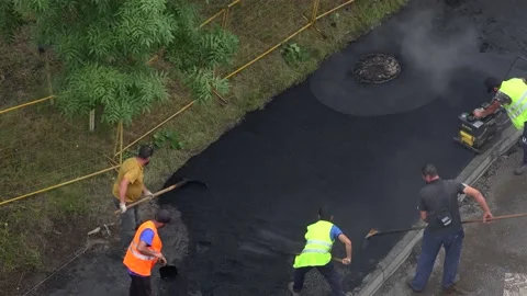 Leveling and laying a new asphalt paveme... | Stock Video | Pond5