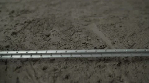 Leveling the floor with a long spatula. ... | Stock Video | Pond5