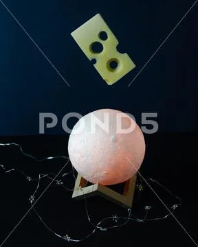 Levitating cheese over the bright moon on dark background Stock Photo ...