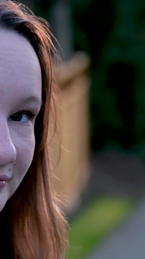 lick lips, turn head girl in park at sun... | Stock Video | Pond5