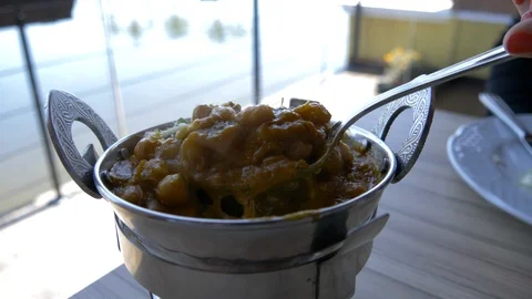 Lifting a spoon out of hot indian food o... | Stock Video | Pond5