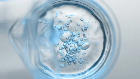 Light blue liquid pouring into beaker fr... | Stock Video | Pond5