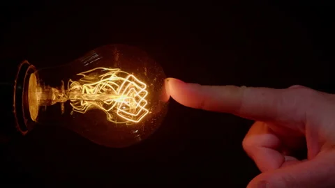 Light bulb lights up from touch of finge... | Stock Video | Pond5