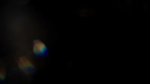 Light leaks particles passing on black b... | Stock Video | Pond5