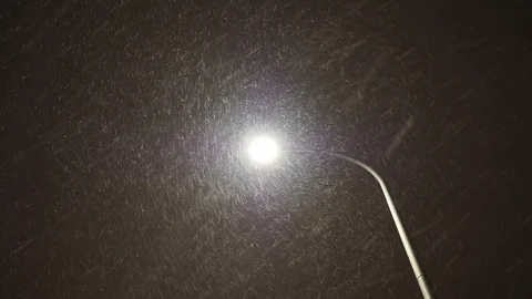 Light of a street lamp and falling snow. | Stock Video | Pond5