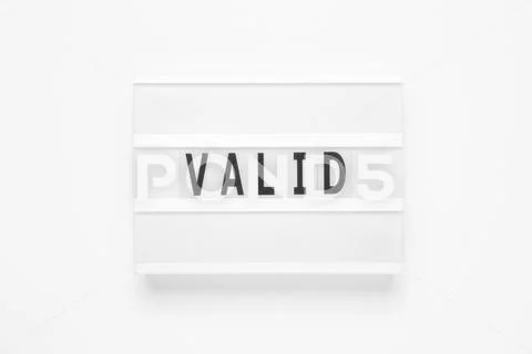 Photograph: Lightbox with word valid on white background #220790927