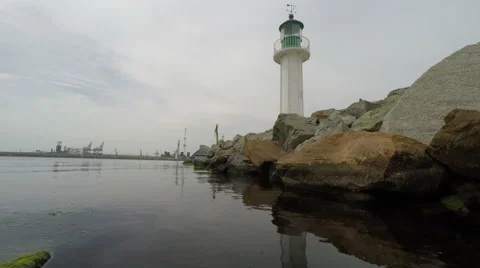 Lighthouse, Calm Sea And Port In The Bac... | Stock Video | Pond5