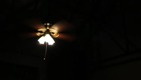 Lights and Spinning Ceiling Fan in Dark ... | Stock Video | Pond5