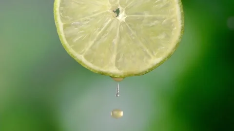 Lime with dripping clear juice on green ... | Stock Video | Pond5