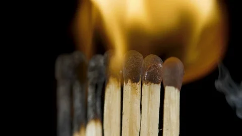 Line of lighted matches on black backgro... | Stock Video | Pond5
