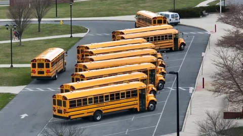 Line up of many school bus vehicles to t... | Stock Video | Pond5