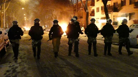 Line of riot officers walking towards ca... | Stock Video | Pond5