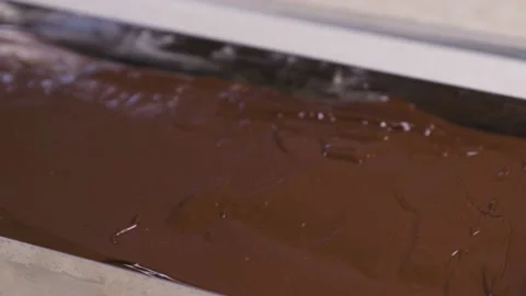Liquid chocolate a baking sheet. Filling... | Stock Video | Pond5