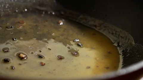 Liquid fat in a pan after frying bacon | Stock Video | Pond5