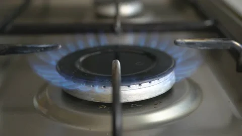 A lit gas burner on the stove. The flame... | Stock Video | Pond5