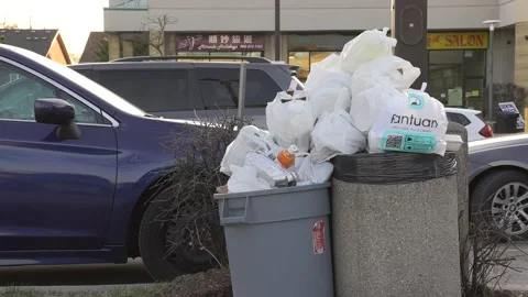 Litter and garbage cans overflowing pile... | Stock Video | Pond5