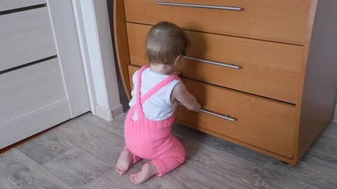 Little baby opens boxes of locker with t... | Stock Video | Pond5