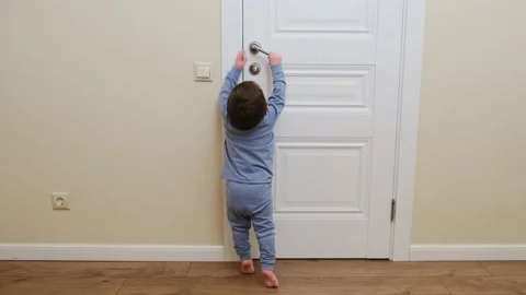 Little baby opens the door. Child pulls ... | Stock Video | Pond5