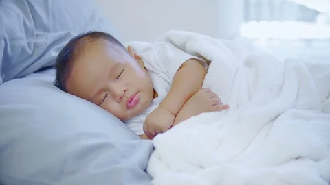 Little baby sleeping alone on bed | Stock Video | Pond5