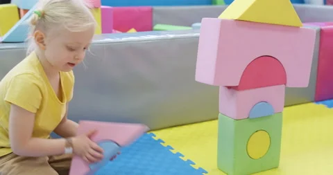 Little blonde girl builds house from col... | Stock Video | Pond5