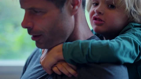 Little boy aggressively hugging father f... | Stock Video | Pond5
