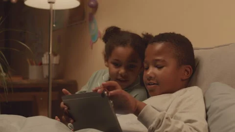 Little Boy and Girl Playing Games on Tab... | Stock Video | Pond5