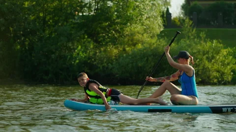 Little Boy And His Mother Floating On Pa... | Stock Video | Pond5