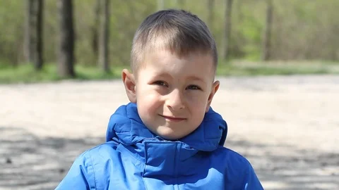 Little boy is blowing in muzzle toy pist... | Stock Video | Pond5