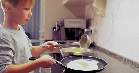 Little boy cooks in the kitchen. Child p... | Stock Video | Pond5