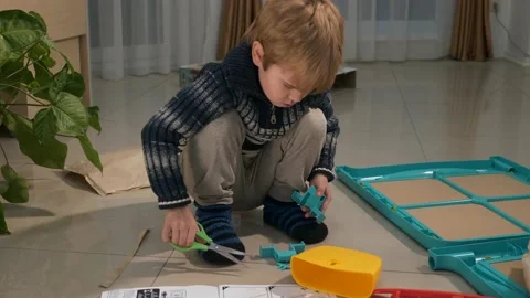 Little Boy Cut with Scissors Plastic Det... | Stock Video | Pond5