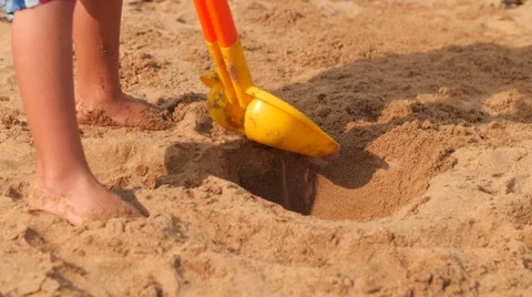 Little boy is digging on beautiful ocean... | Stock Video | Pond5