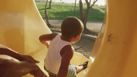 Little Boy Getting Pushed Down the Slide... | Stock Video | Pond5