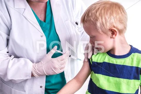 Little boy is given an injection by the family doctor Stock Image #49799341