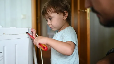 Little boy helping father to fix washing... | Stock Video | Pond5