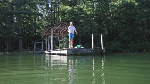 Jumping Off Dock Stock Video Footage | Royalty Free Jumping Off Dock Videos | Pond5