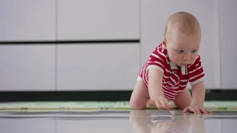 Little boy is learning to crawl. A serio... | Stock Video | Pond5