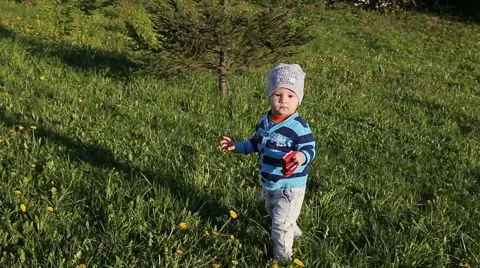 Little boy making first steps | Stock Video | Pond5