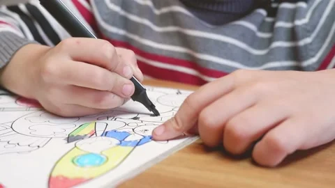 A little boy paints a coloring with cray... | Stock Video | Pond5