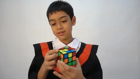 Little boy playing Rubik cube | Stock Video | Pond5