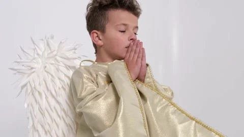 Little boy praying to God, he is dressed... | Stock Video | Pond5