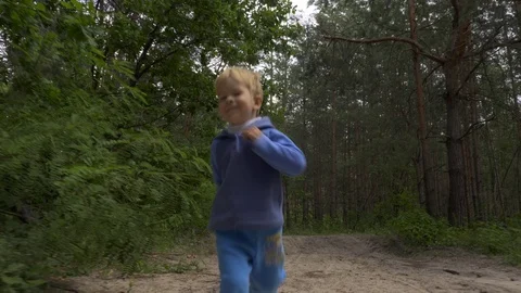 Little Boy Running Alone in the Forest. ... | Stock Video | Pond5