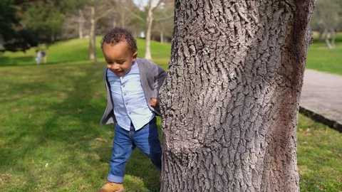 Little boy running around tree, playing ... | Stock Video | Pond5