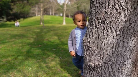 Little boy running around tree, playing ... | Stock Video | Pond5
