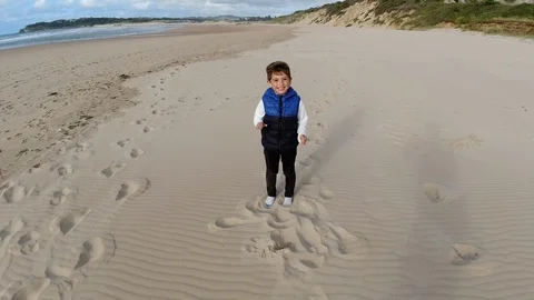 Little boy running to the camera. Slow m... | Stock Video | Pond5