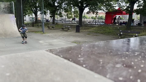 A little boy on a scooter falls while tr... | Stock Video | Pond5