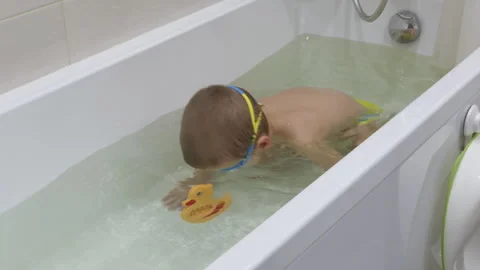Little Boy Taking a Bath, Learning to Ho... | Stock Video | Pond5