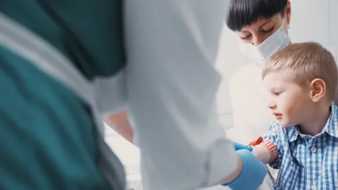 little boy is taking blood from a vein f... | Stock Video | Pond5