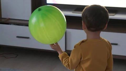 little boy trying to inflate balloon. ba... | Stock Video | Pond5