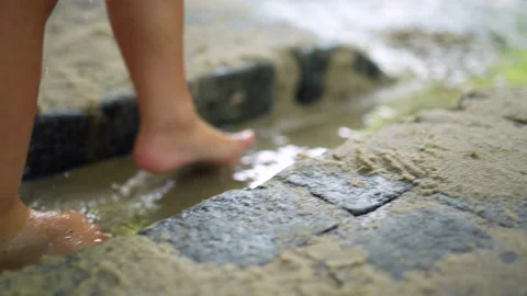 Little boy walking barefoot outside in w... | Stock Video | Pond5