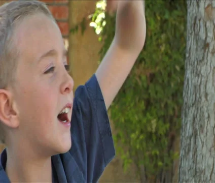 Little boy yells & waves goodbye | Stock Video | Pond5